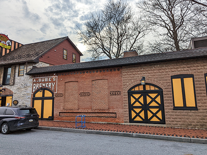 The historic façade of Bube's Brewery stands proudly on Mount Joy's main street, its yellow doors beckoning like a time portal to Pennsylvania's brewing past.