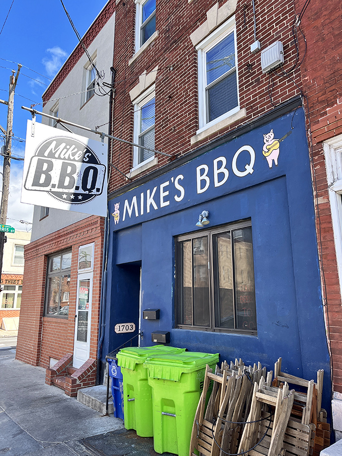The blue storefront of Mike's BBQ stands out like a beacon of smoky hope on South Philly's 11th Street, complete with an adorable pig logo that practically winks at you.