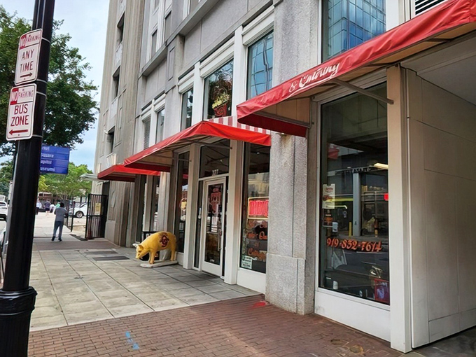 The iconic red awning and pig statue welcome you to Clyde Cooper's – where barbecue dreams come true since 1938.