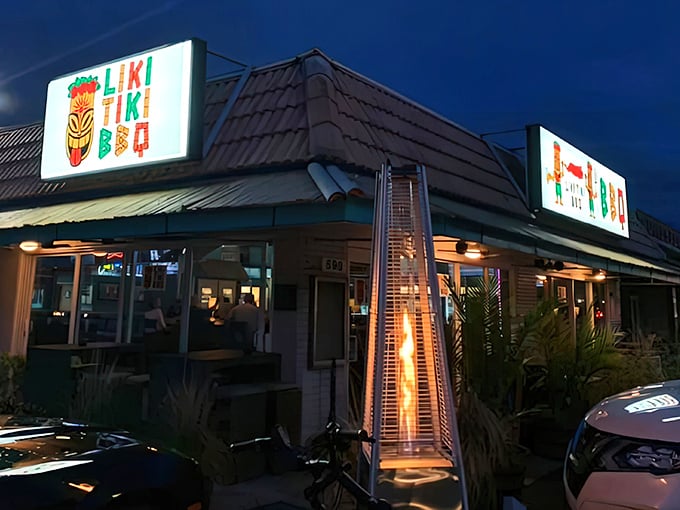 The neon glow of Liki Tiki BBQ beckons like a tropical lighthouse guiding hungry souls to barbecue paradise.