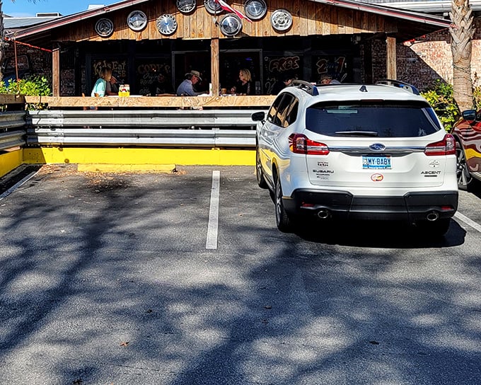 The rustic wooden exterior with its hub cap decorations promises the kind of authentic roadhouse experience that makes food taste better somehow.