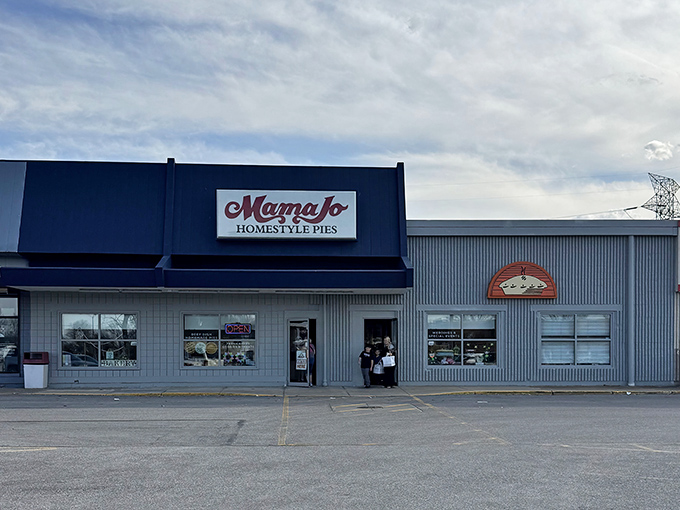 The blue awning and bold red script of Mama Jo's storefront promises pie paradise within—no fancy frills needed when the goods inside speak volumes.