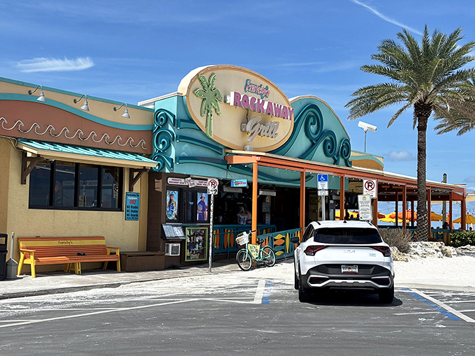 The turquoise and coral exterior of Frenchy's Rockaway Grill stands like a tropical mirage against Clearwater's pristine white sand beach.