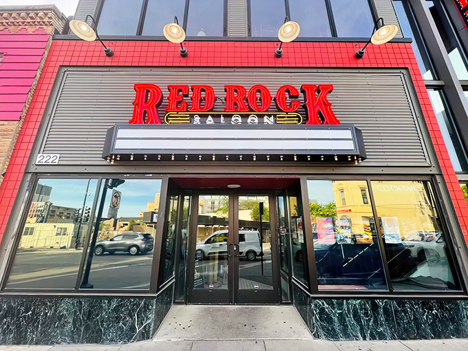 The bold red signage of Red Rock Saloon beckons like a neon oasis in downtown Madison, promising country comfort and culinary adventures within those glass doors.