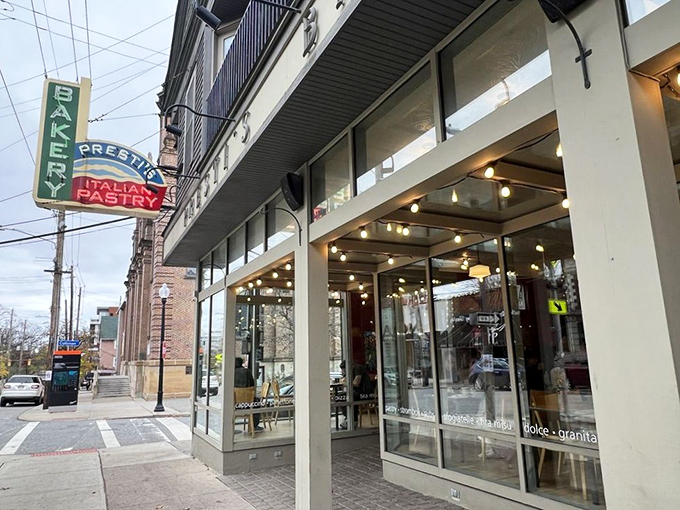 The iconic green and red neon sign of Presti's Bakery stands as a beacon of Italian deliciousness in Cleveland's Little Italy neighborhood, promising sweet treasures within.