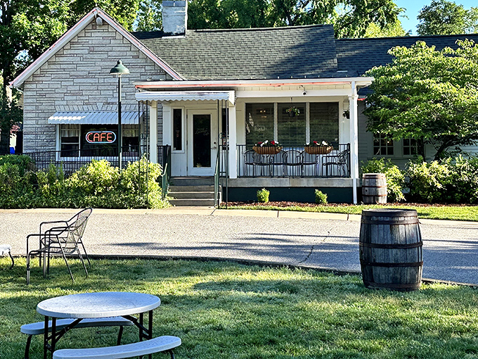 The charming exterior of Loveless Cafe welcomes visitors with its quaint porch and rustic barrel—Southern hospitality before you even step inside.