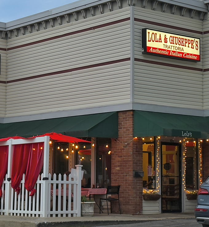 The charming storefront of Lola & Giuseppe's beckons with its green awning and white picket fence – like an Italian grandmother waving you in for dinner.