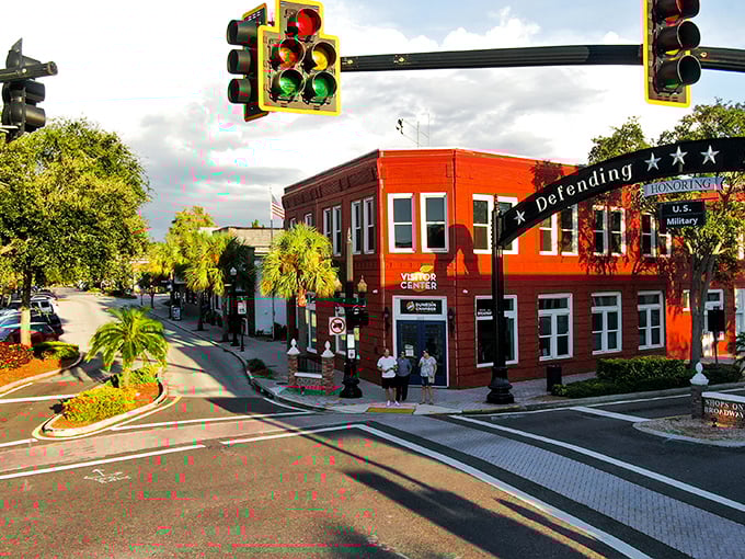 Downtown Dunedin's vibrant intersection showcases the town's colorful character. That bright red building isn't just eye-catching—it's a beacon of the community spirit that makes this place special.