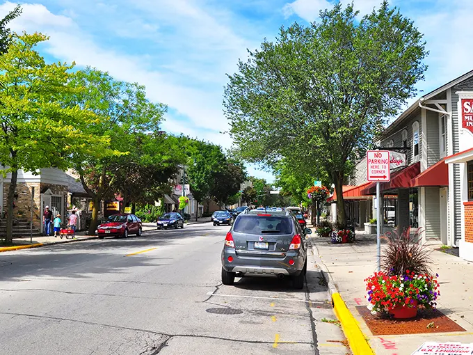 Cedarburg’s inviting downtown street features leafy trees, cheerful flowers, and charming storefronts, creating the perfect backdrop for a leisurely stroll.