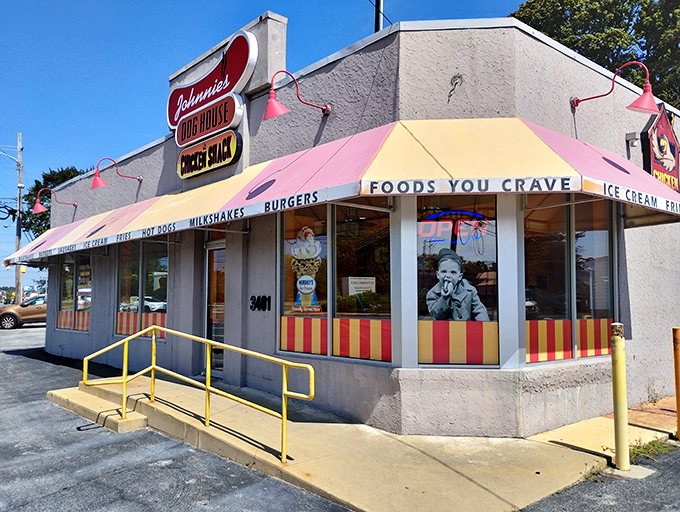 The pink and white striped awning of Johnnie's beckons like a carnival of comfort food, promising simple pleasures that transcend culinary trends.