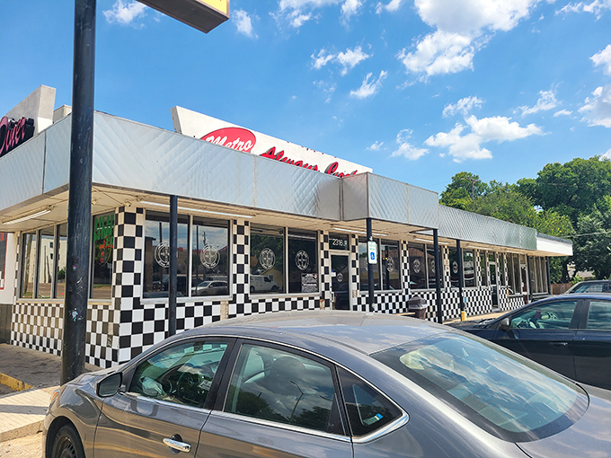 The black and white checkered exterior isn't just nostalgic design—it's a beacon signaling "real food ahead" to hungry Dallas travelers.