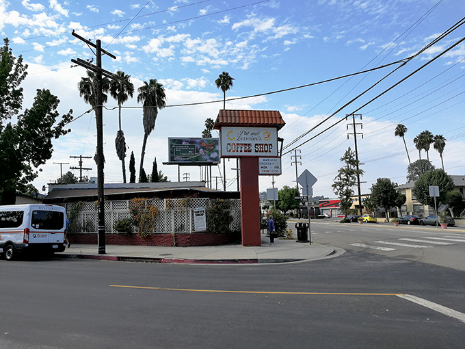 The Spanish-style exterior of Pat & Lorraine's welcomes hungry patrons with its terracotta roof and charming red door—a humble facade hiding breakfast greatness within.