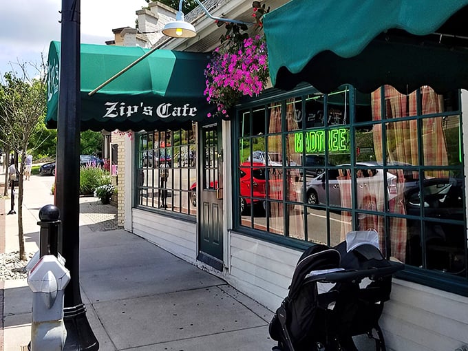 The unassuming storefront of Zip's Cafe stands proudly on Mount Lookout Square, its green awning like a beacon for burger enthusiasts seeking authentic Cincinnati comfort food.