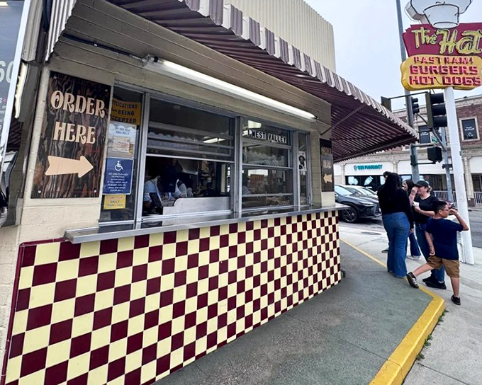The yellow sign doesn't lie—this unassuming building houses pastrami dreams that have kept Californians coming back for generations.