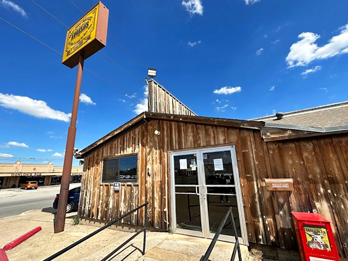 The unassuming wooden exterior of Angelo's might fool you, but Texans know better—barbecue greatness often hides behind humble facades.