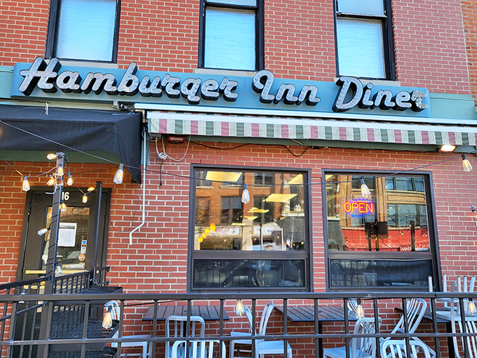 The iconic blue signage of Hamburger Inn Diner beckons hungry travelers like a neon lighthouse on Delaware's main street, promising comfort food salvation inside.