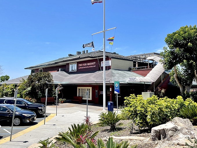 The Fish Market's nautical exterior stands like a welcoming lighthouse for hungry seafood pilgrims. Those flags aren't just for show—they're signaling "fresh catch ahead!"