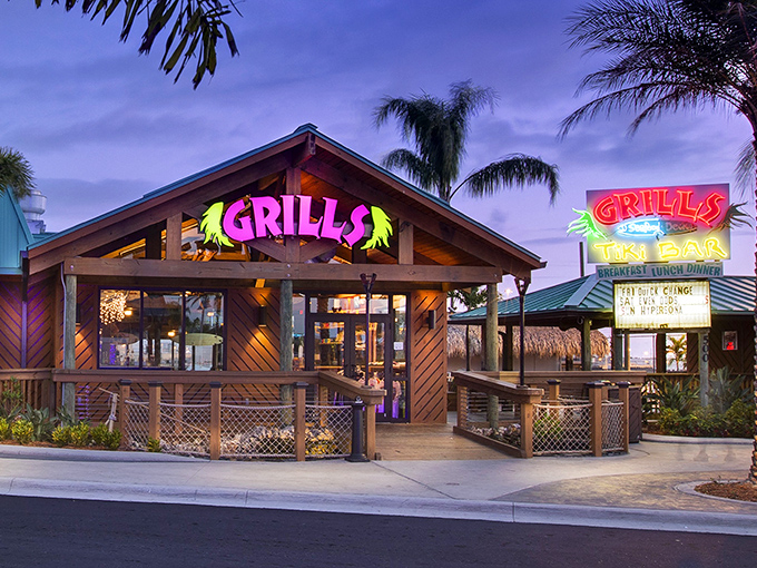 The neon glow of Grills beckons like a tropical lighthouse, promising seafood salvation after a day of Florida sun.