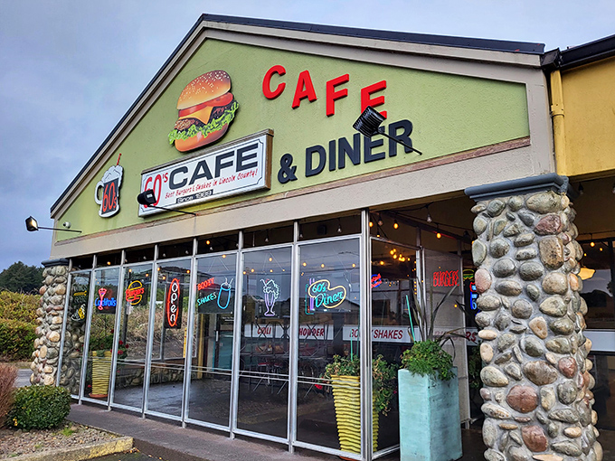 The lime green exterior with its giant burger sign isn't subtle—it's a beacon calling to hungry travelers like a retro lighthouse for your appetite.