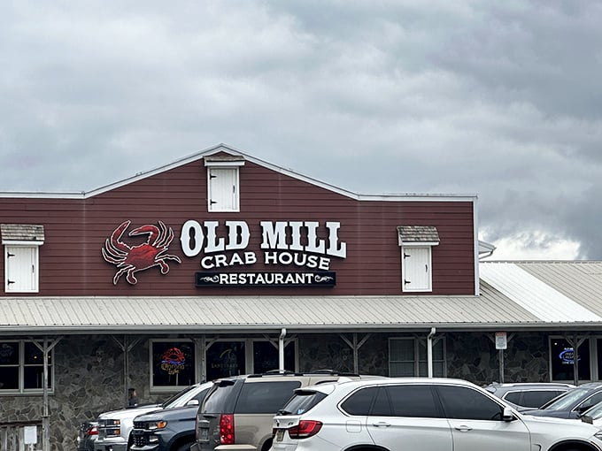 The rustic burgundy exterior with its bold crab logo promises seafood salvation for weary travelers. No pretension, just delicious anticipation.