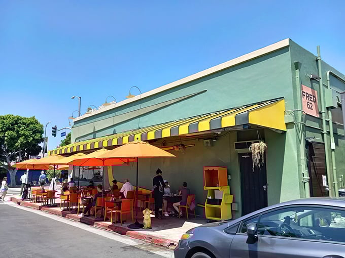 Fred 62's mint-green exterior with vibrant orange awnings stands like a mid-century mirage on Vermont Avenue, beckoning hungry travelers 24/7.
