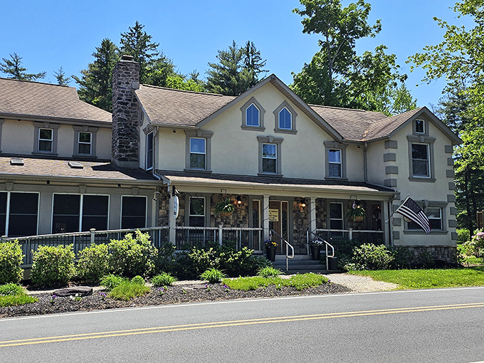 The stately exterior of Frogtown Chophouse glows with warm invitation at dusk, like a beacon of culinary promise in the Pocono Mountains. 
