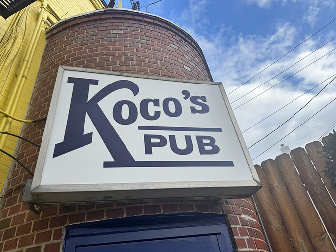 The sunshine-yellow exterior of Koco's Pub isn't just a building—it's a beacon of crab cake excellence standing proudly on a Baltimore corner.