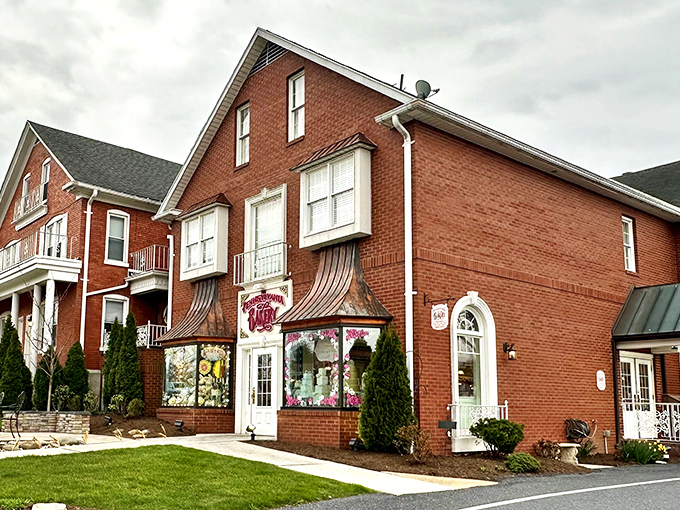 The charming brick exterior of The Pennsylvania Bakery beckons with its distinctive copper awnings and colorful window displays—like a sweet-tooth siren call to dessert lovers.