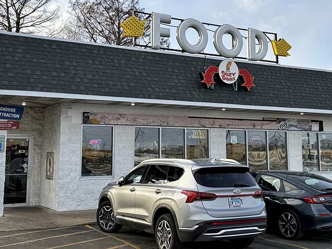 The iconic Cozy Dog sign beckons hungry travelers like a Route 66 lighthouse, promising comfort food salvation just off the highway.