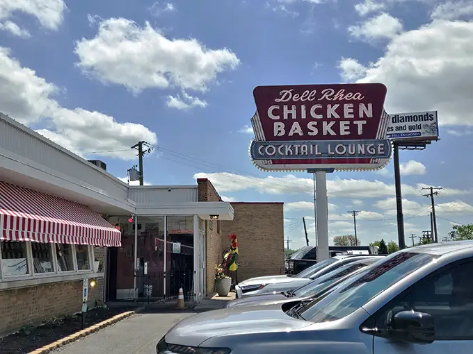 The iconic red and white awning beckons hungry travelers like a Route 66 mirage. This isn't just a restaurant—it's a time machine with fried chicken.