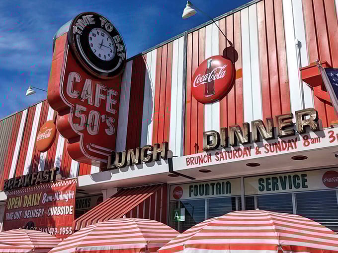 The red and white striped awning of Café 50's isn't just eye-catching—it's practically a time machine disguised as architecture on Santa Monica Boulevard.