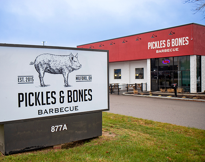The bright red exterior of Pickles & Bones stands like a beacon for barbecue pilgrims, complete with a hand-drawn pig that practically winks at you.