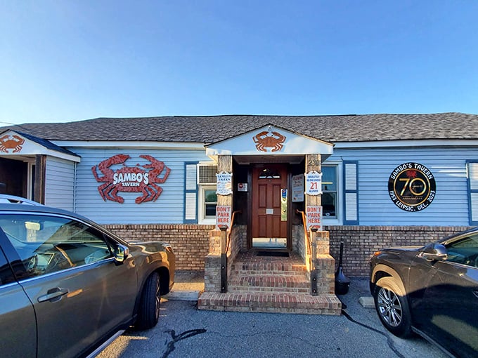 The blue exterior of Sambo's Tavern stands as a beacon for crab lovers, with those giant red crabs practically screaming, "Get in here, hungry traveler!"
