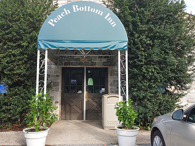 The stone facade and distinctive blue awning of Peach Bottom Inn isn't trying to be trendy—it's too busy being timeless.
