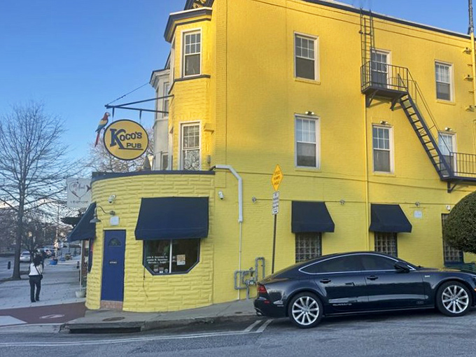 The sunshine-yellow exterior of Koco's Pub isn't just a building—it's a beacon of crab cake excellence standing proudly on a Baltimore corner.