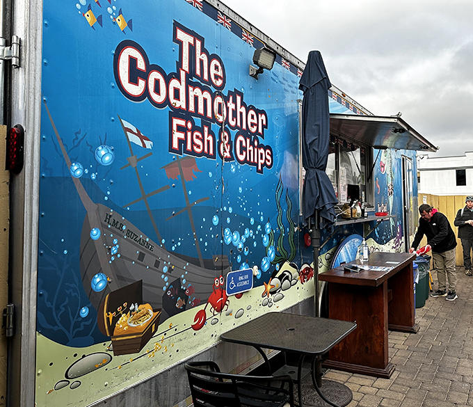 The bright blue food truck stands like an underwater oasis in Fisherman's Wharf, promising British-style seafood treasures with its playful "In Cod We Trust" motto.
