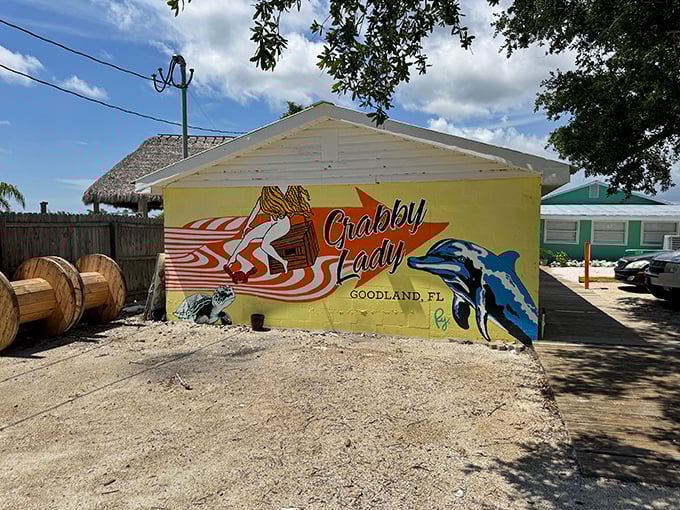 The sunshine-yellow exterior of Crabby Lady announces itself with all the subtlety of a Jimmy Buffett concert—complete with dolphins, dogs, and enough coastal charm to fill a beach novel.