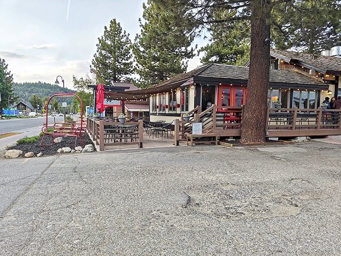 Nestled among towering pines, The Warming Hut's inviting deck practically whispers, "Come sit awhile," after a day of mountain adventures.