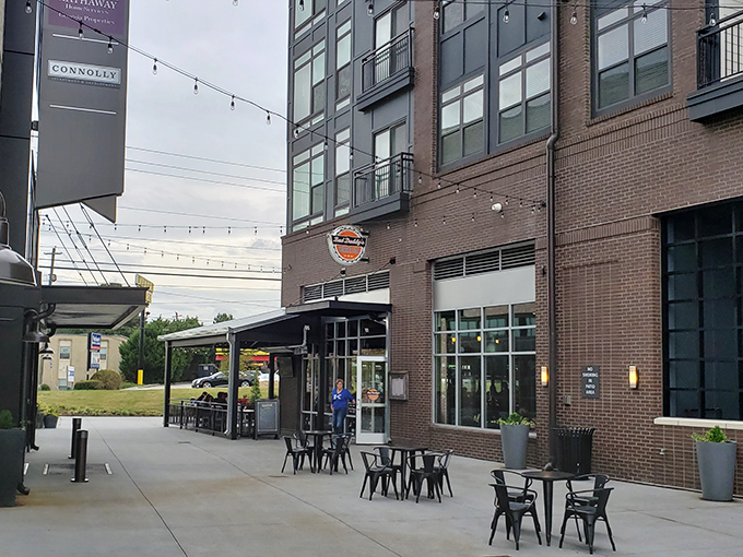 Bad Daddy's modern brick exterior beckons burger lovers with its inviting patio seating and string lights—urban comfort food paradise in Chamblee's evolving landscape.