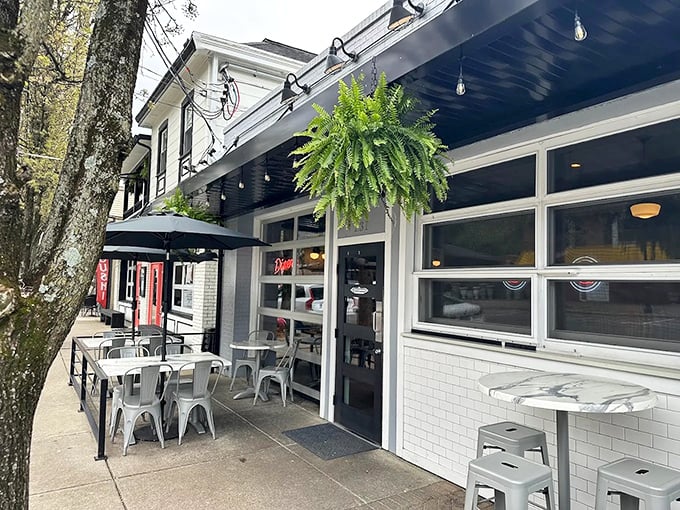 The white-brick façade of The Governor welcomes diners with charming outdoor seating. Hanging ferns and street-side tables create the perfect people-watching perch.