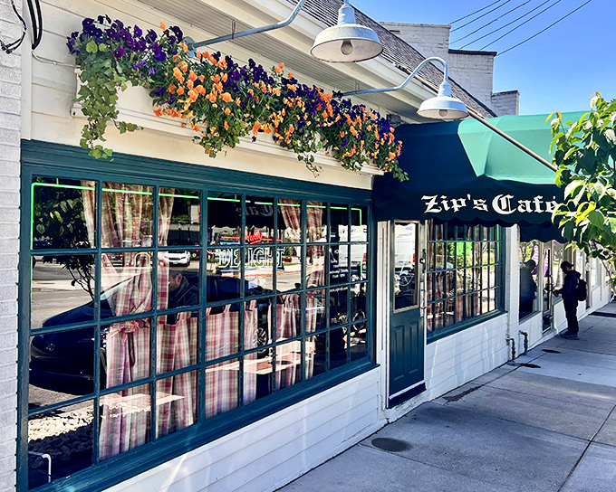 The charming exterior of Zip's Cafe welcomes you with colorful flower boxes and that iconic green awning—a Cincinnati landmark that promises comfort without pretension.
