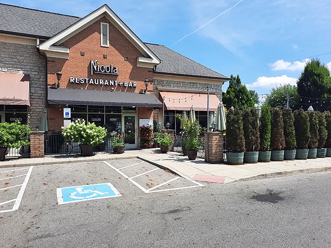 The unassuming brick exterior of Nicola hides culinary treasures within—like finding a Lamborghini parked behind a garden shed.