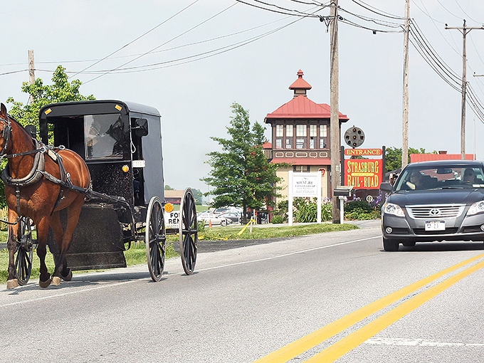 Where modern meets traditional – Amish buggies share the road with cars as they have for generations at Strasburg's iconic entrance.