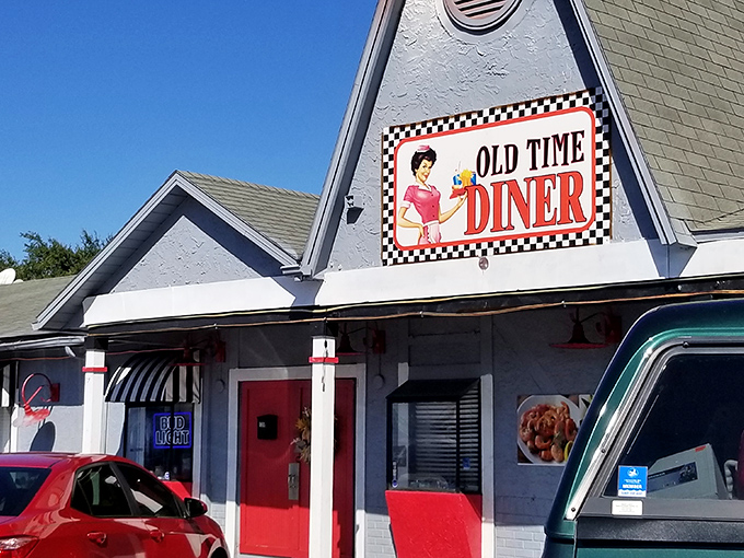 The classic checkered border on this sign isn't just decoration—it's a promise that what awaits inside is the real deal, no fancy pretensions required.