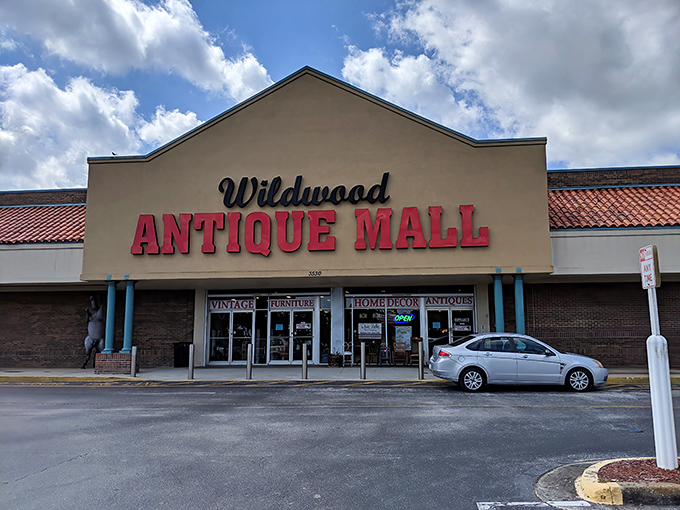 The unassuming exterior of Wildwood Antique Mall belies the treasure trove within. Like a time-travel portal disguised as a strip mall storefront.