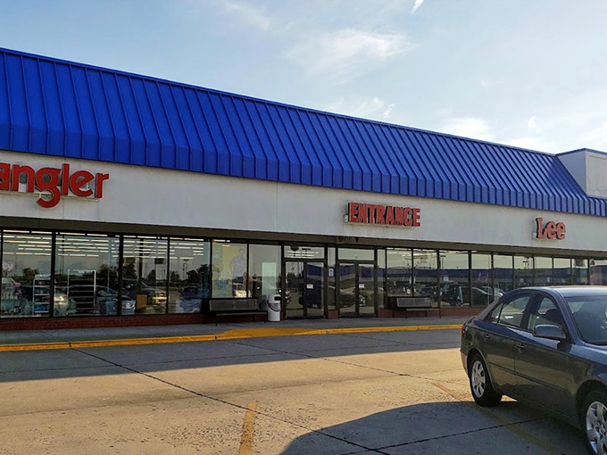 The iconic blue roof of Sikeston Factory Outlet Stores stands like a retail oasis in Missouri, promising treasure hunts where Wrangler meets wallet-friendly.