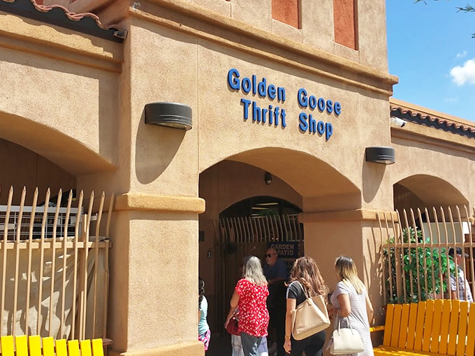 The stucco facade of Golden Goose Thrift Shop beckons like a desert mirage, promising treasures within its Spanish-style walls.