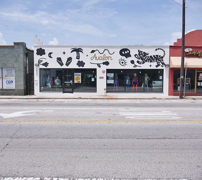 The whimsical storefront of Avalon Exchange beckons with playful palm trees and cosmic symbols, promising a treasure hunt unlike any mall experience.