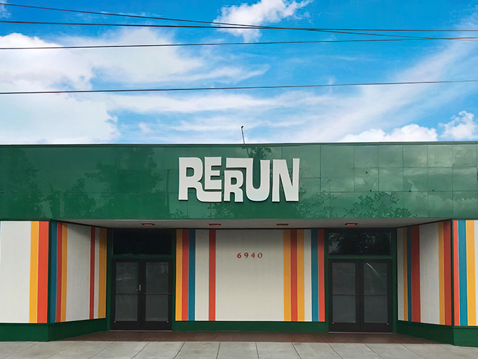 RERUN's vibrant green facade with rainbow stripes isn't just eye-catching—it's a preview of the technicolor treasure hunt waiting inside. Portland's vintage paradise beckons!