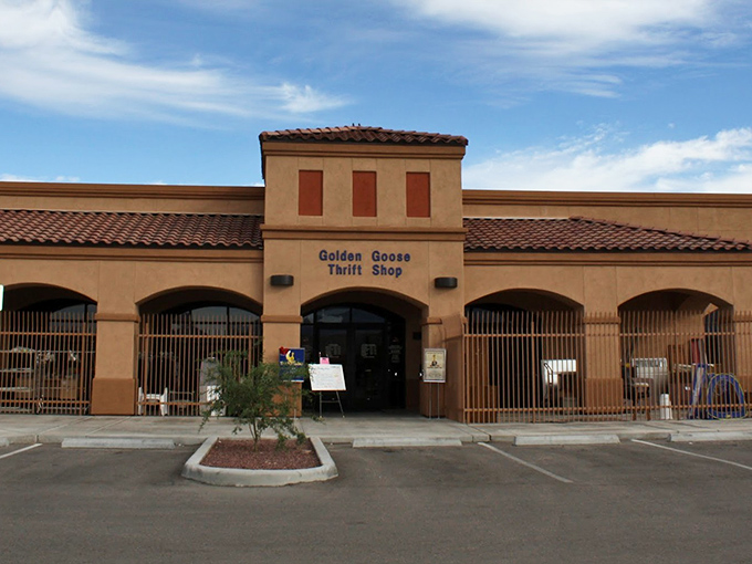 The unassuming exterior of Golden Goose Thrift Shop stands like a treasure chest in the desert, promising bargain-hunting adventures behind its Spanish-style façade.